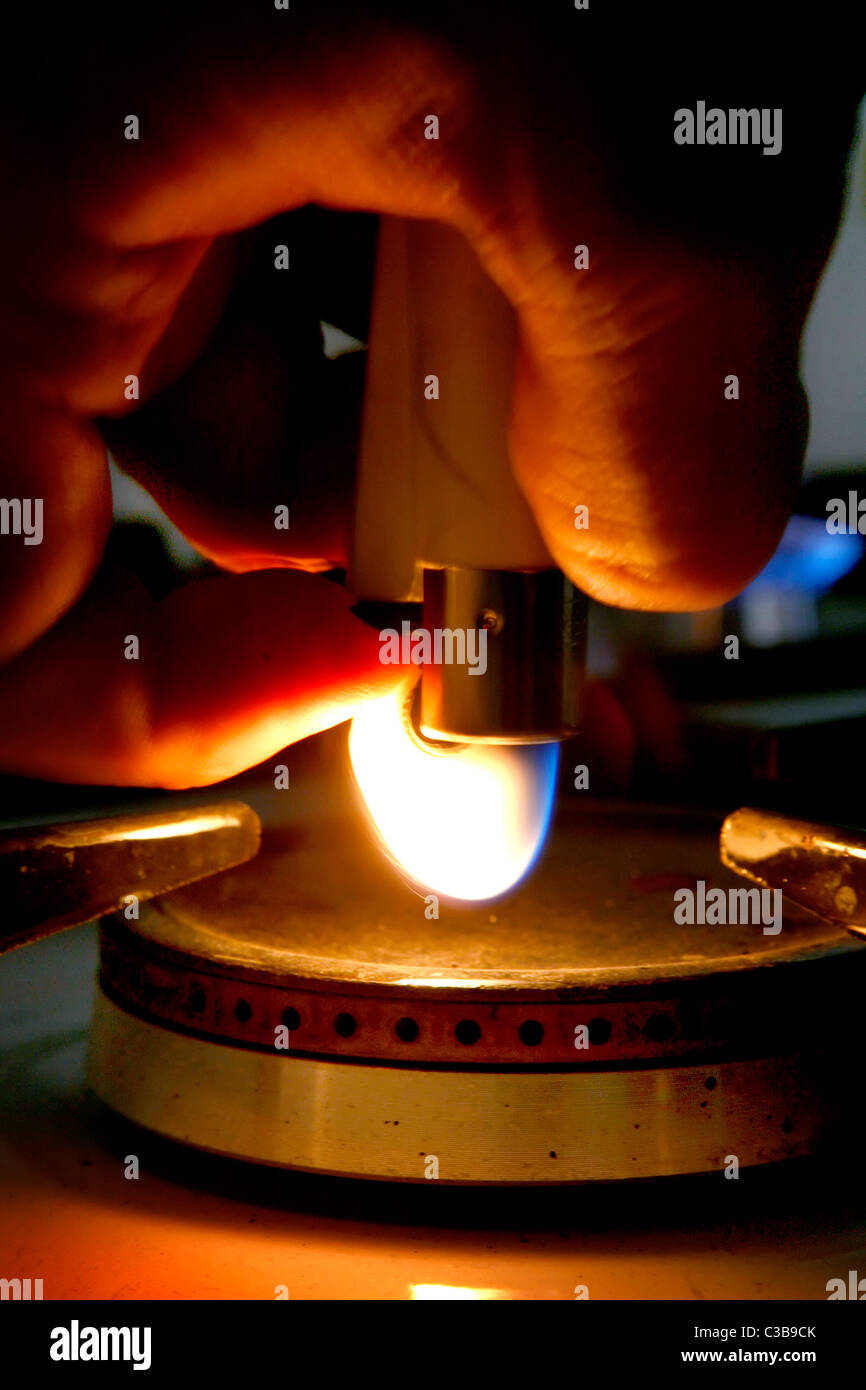 Picture shows a man's hand lighting a gas ring with a lighter Stock ...