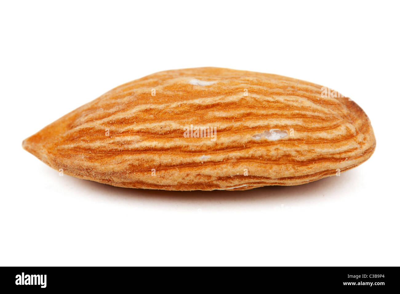 one almond closeup isolated on white background Stock Photo - Alamy