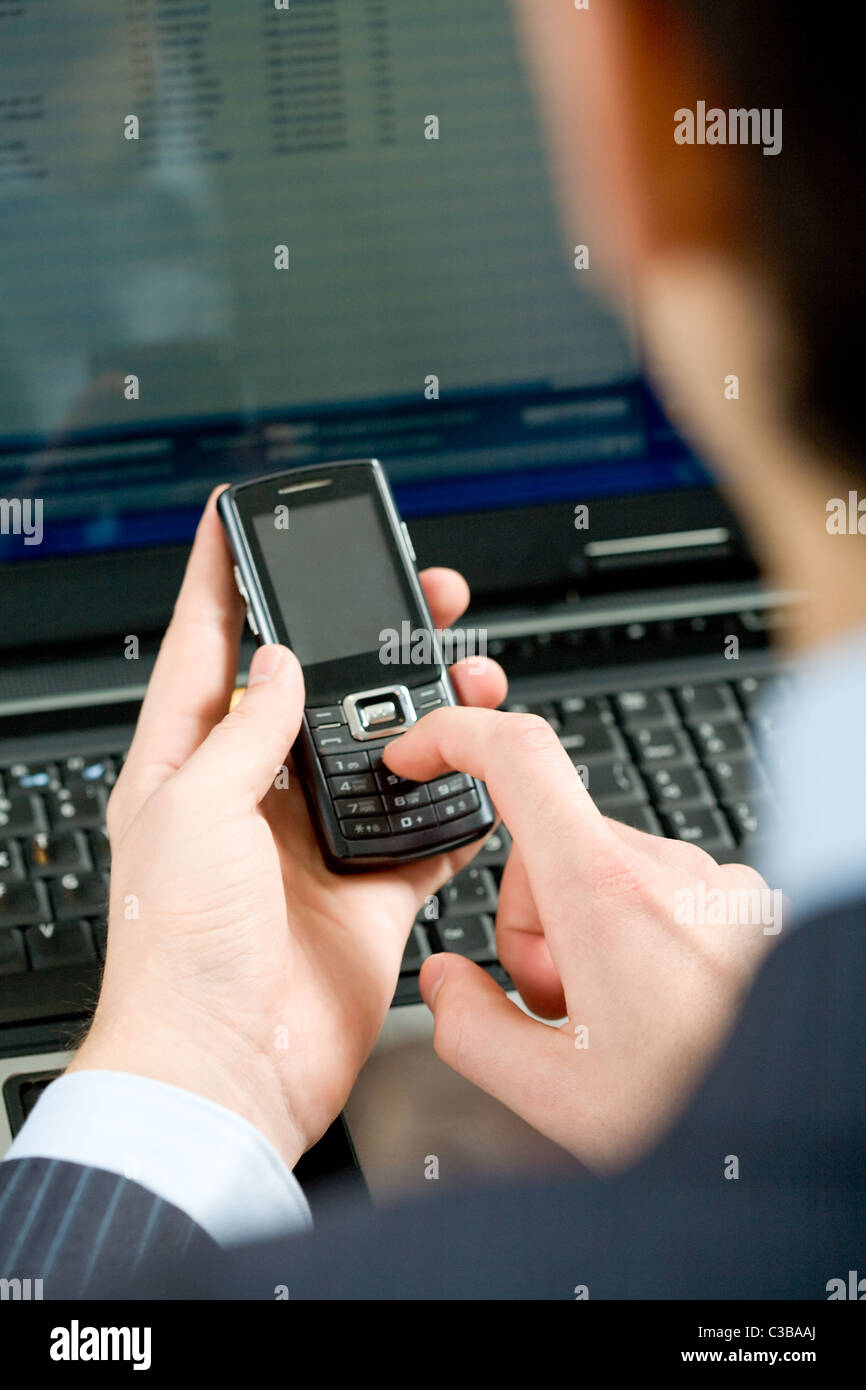 Photo of male hand holding cellular phone and writing sms Stock Photo ...