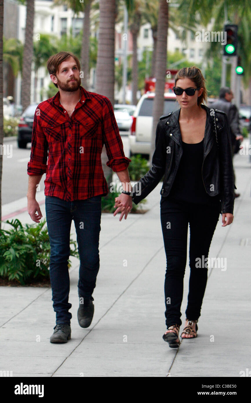 Caleb Followill of rock band Kings of Leon holds hands with a female ...