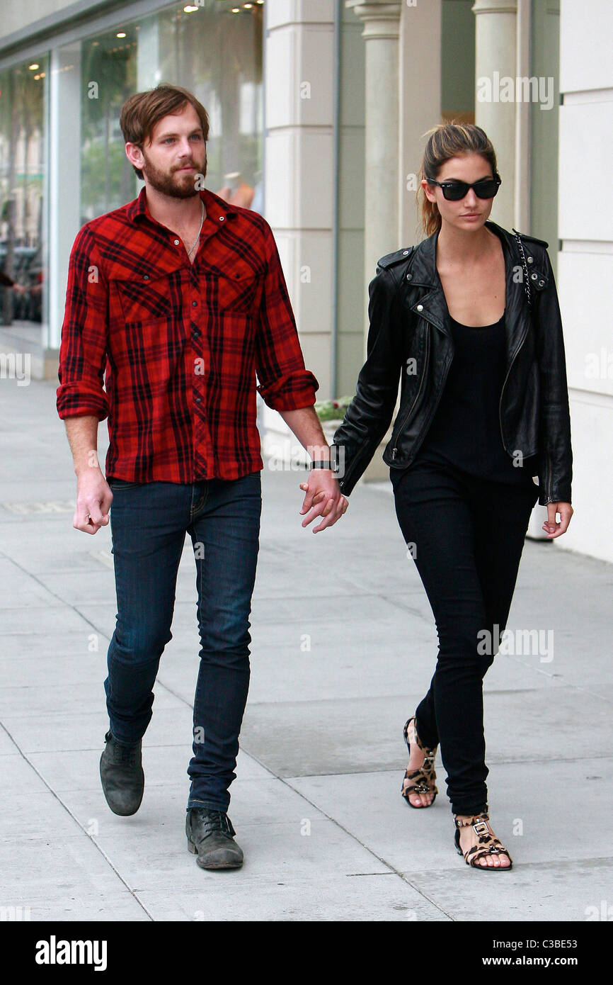 Caleb Followill of rock band Kings of Leon holds hands with a female ...