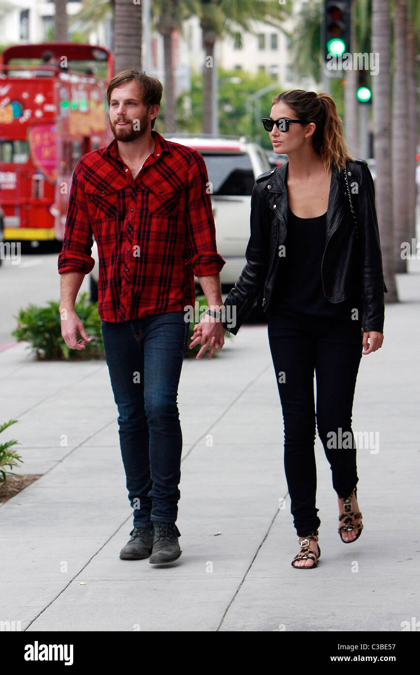 Caleb Followill of rock band Kings of Leon holds hands with a female ...