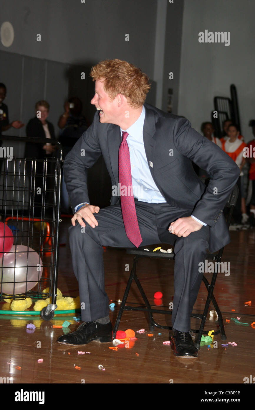 Prince Harry plays with children during a visit to the Harlem Children ...