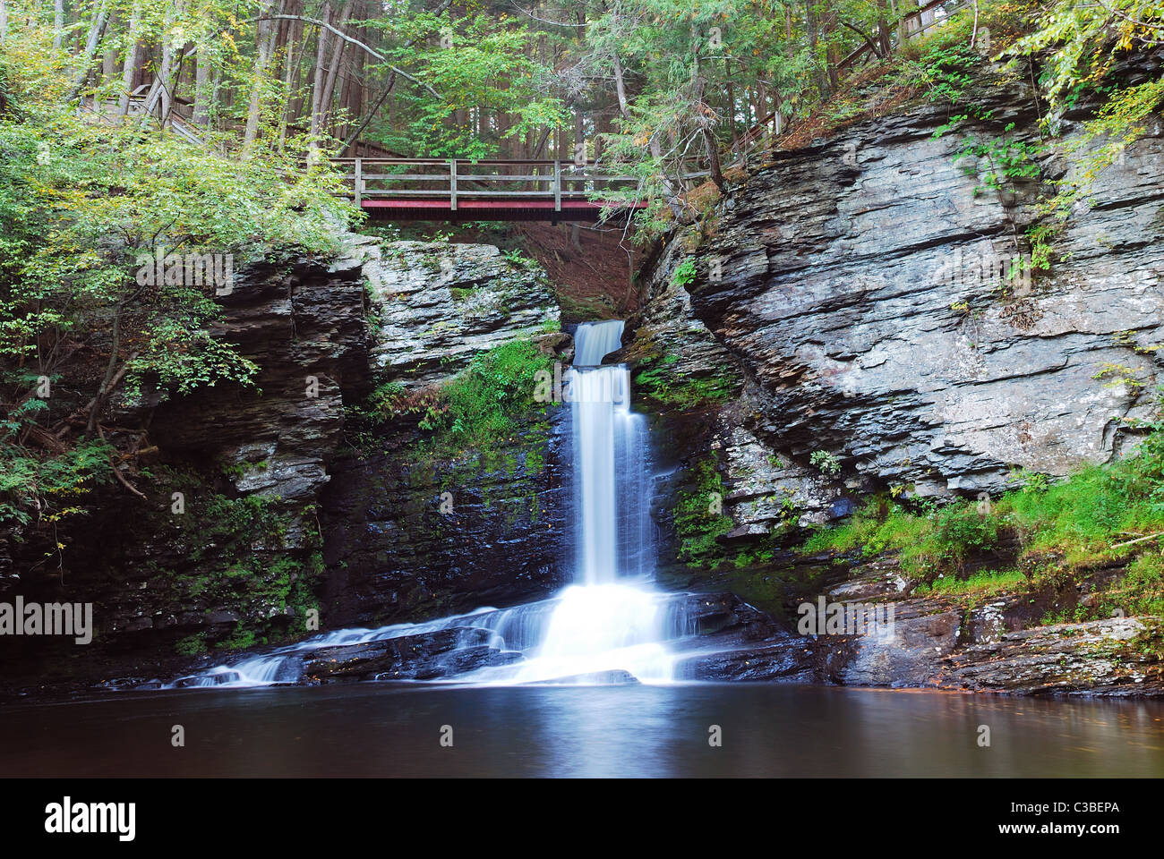 Waterfall with bridge and woods in mountain Stock Photo - Alamy