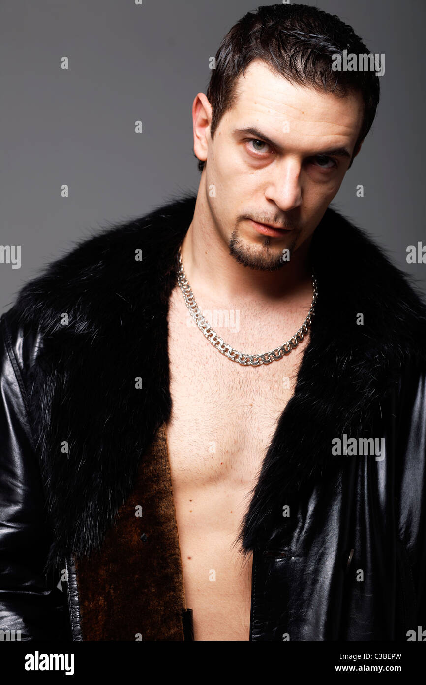 Portrait of a handsome man in leather jacket over white background ...