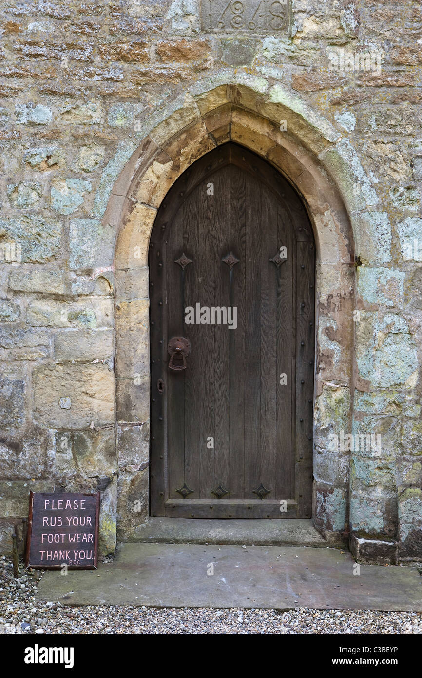 Side door and sign at All Saints Church Thwing East Yorkshire Stock ...