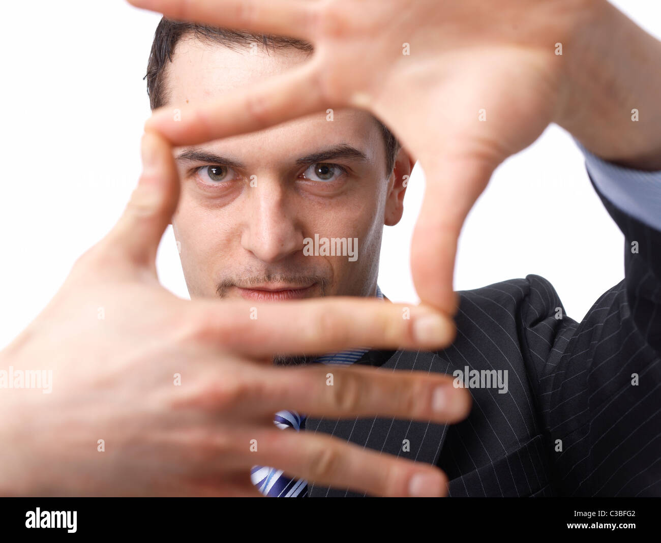 Close up portrait of a confident young businessman making a frame shape ...