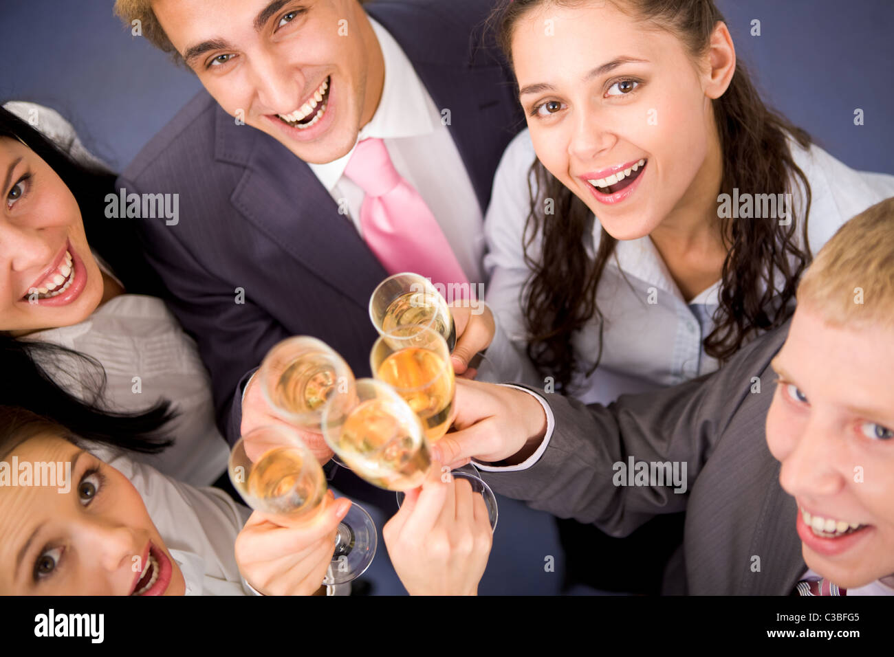 Photo of happy friends cheering up during corporate party Stock Photo ...