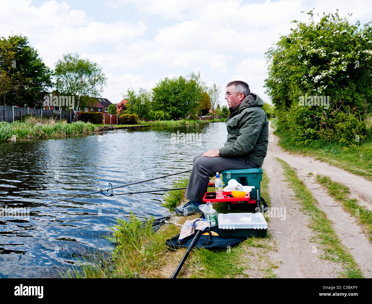 Angler fishing on the Rochdale canal, Middleton, Lancashire, England ...