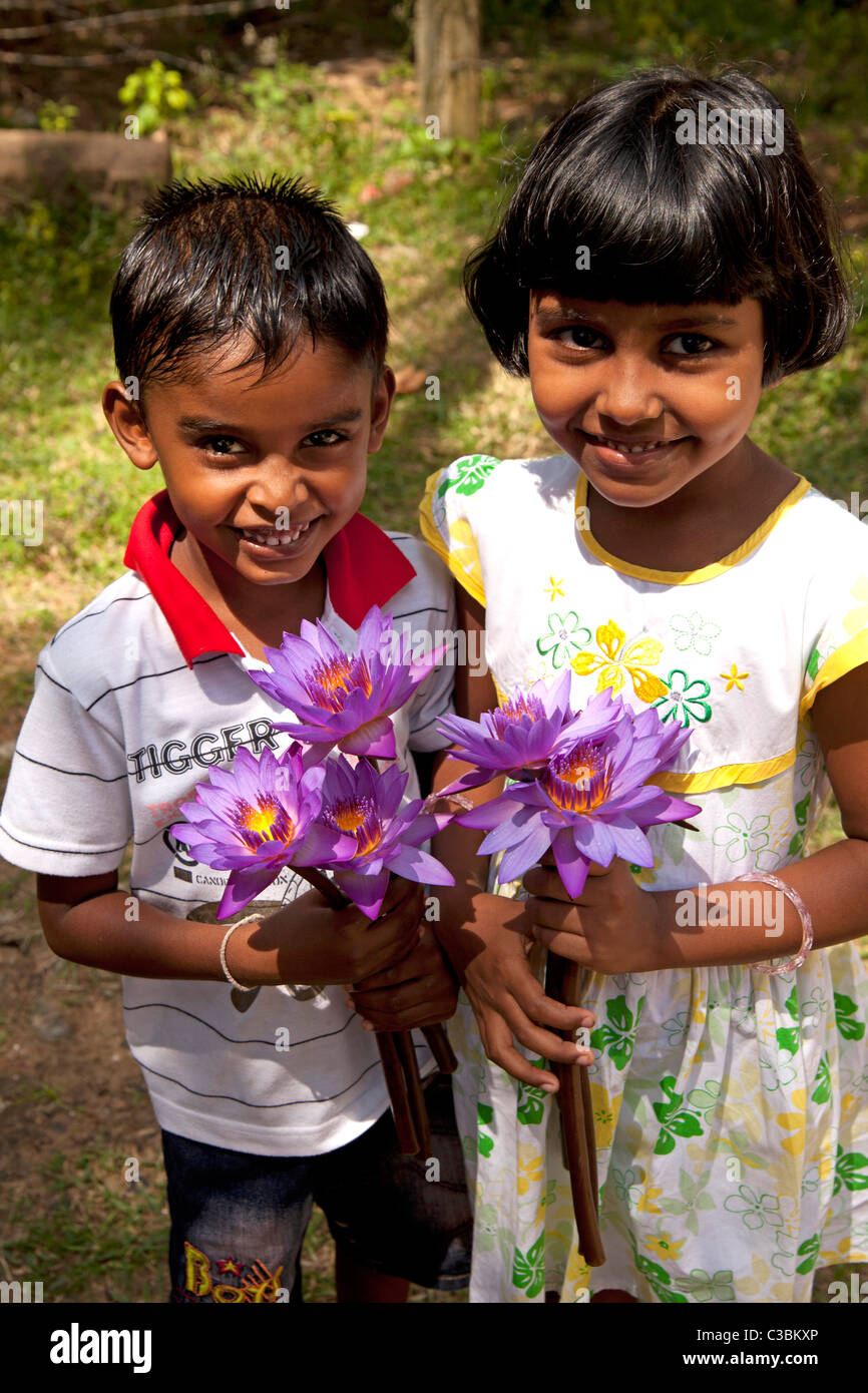 children offering flowers for buddha at the Devinuwara Devalaya Temple ...