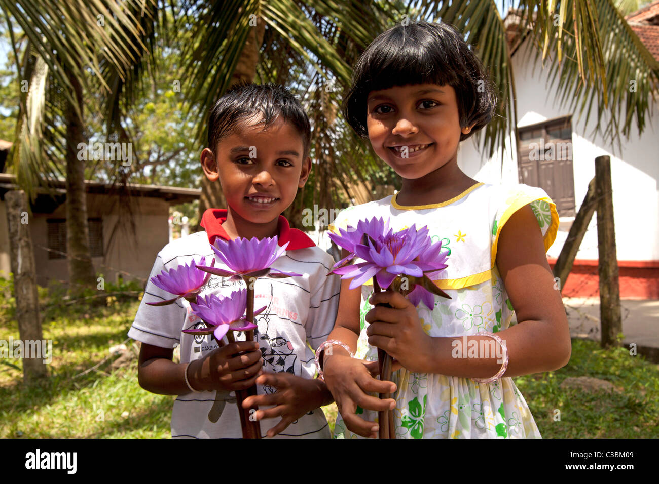 children offering flowers for buddha at the Devinuwara Devalaya Temple ...