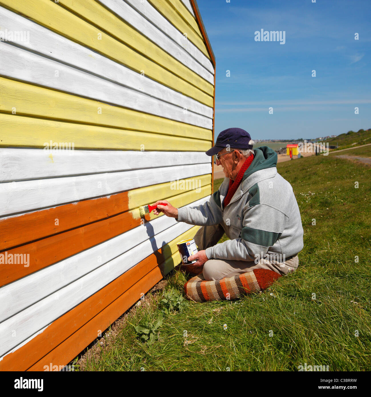 Man painting his beach hut Stock Photo - Alamy