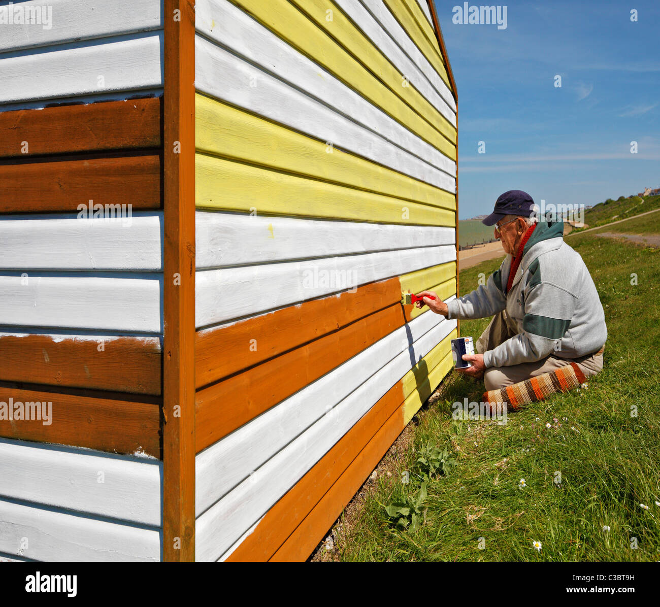 Man painting his beach hut Stock Photo - Alamy