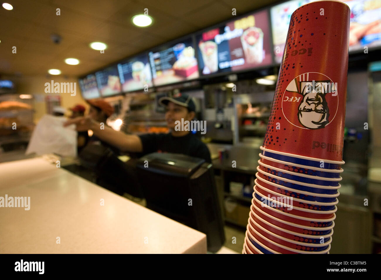 A kfc employee serving hungry customer in hi-res stock photography and ...