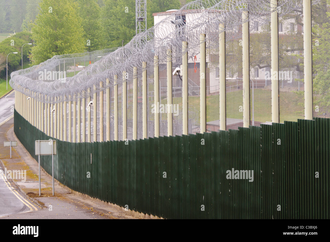 Prison fence with coiled razor wire and CCTV Cameras Stock Photo - Alamy