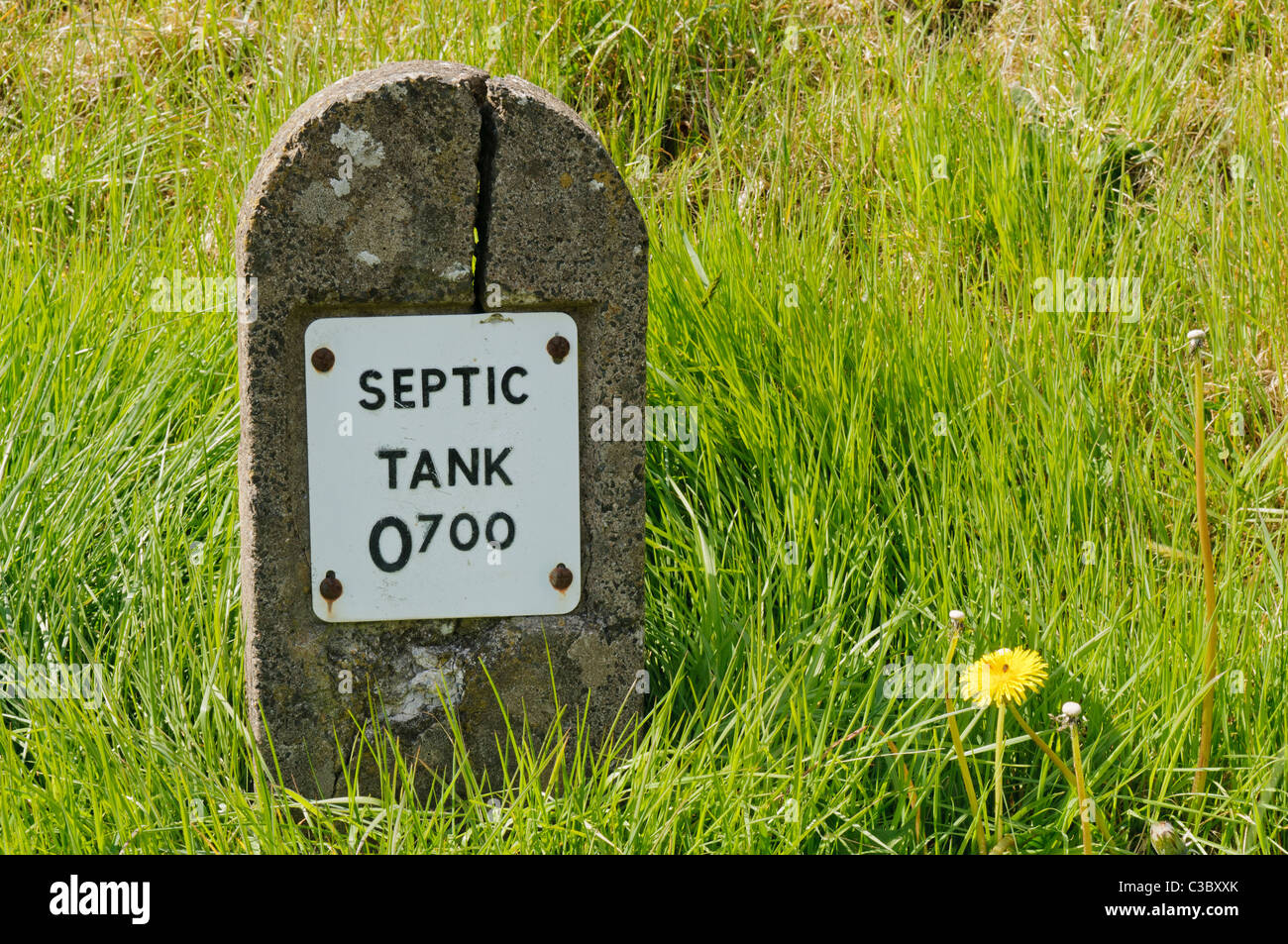Concrete post marking the location of a septic tank Stock Photo - Alamy