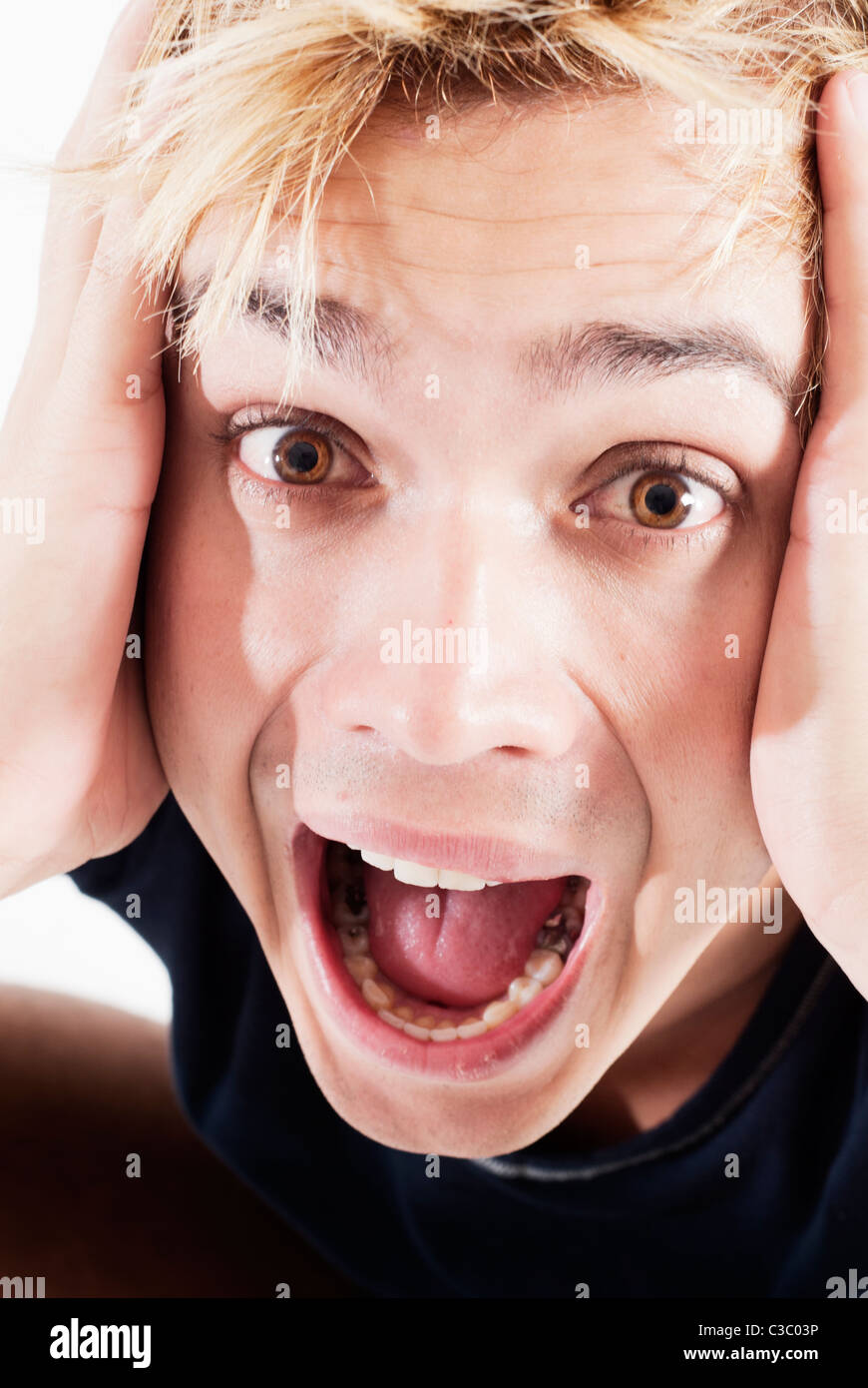 front close up of young man screaming with his hands on face Stock ...