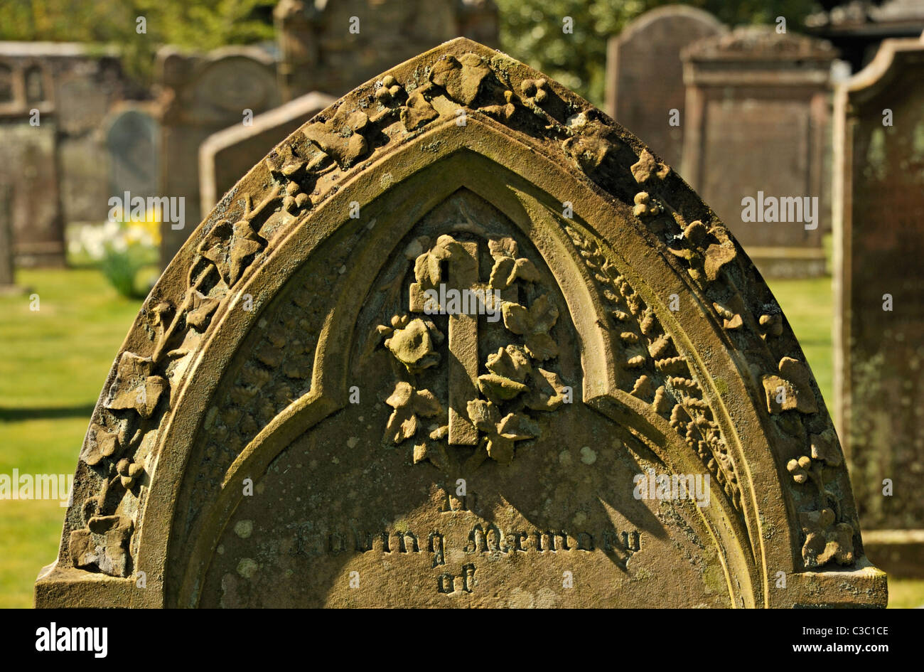 Gravestone with cross, ivy and fern design. Church of Saint Kentigern ...