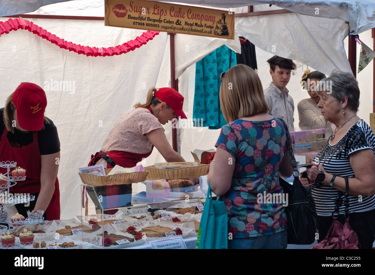 Ladies serving on a cake stall at street market Stock Photo - Alamy