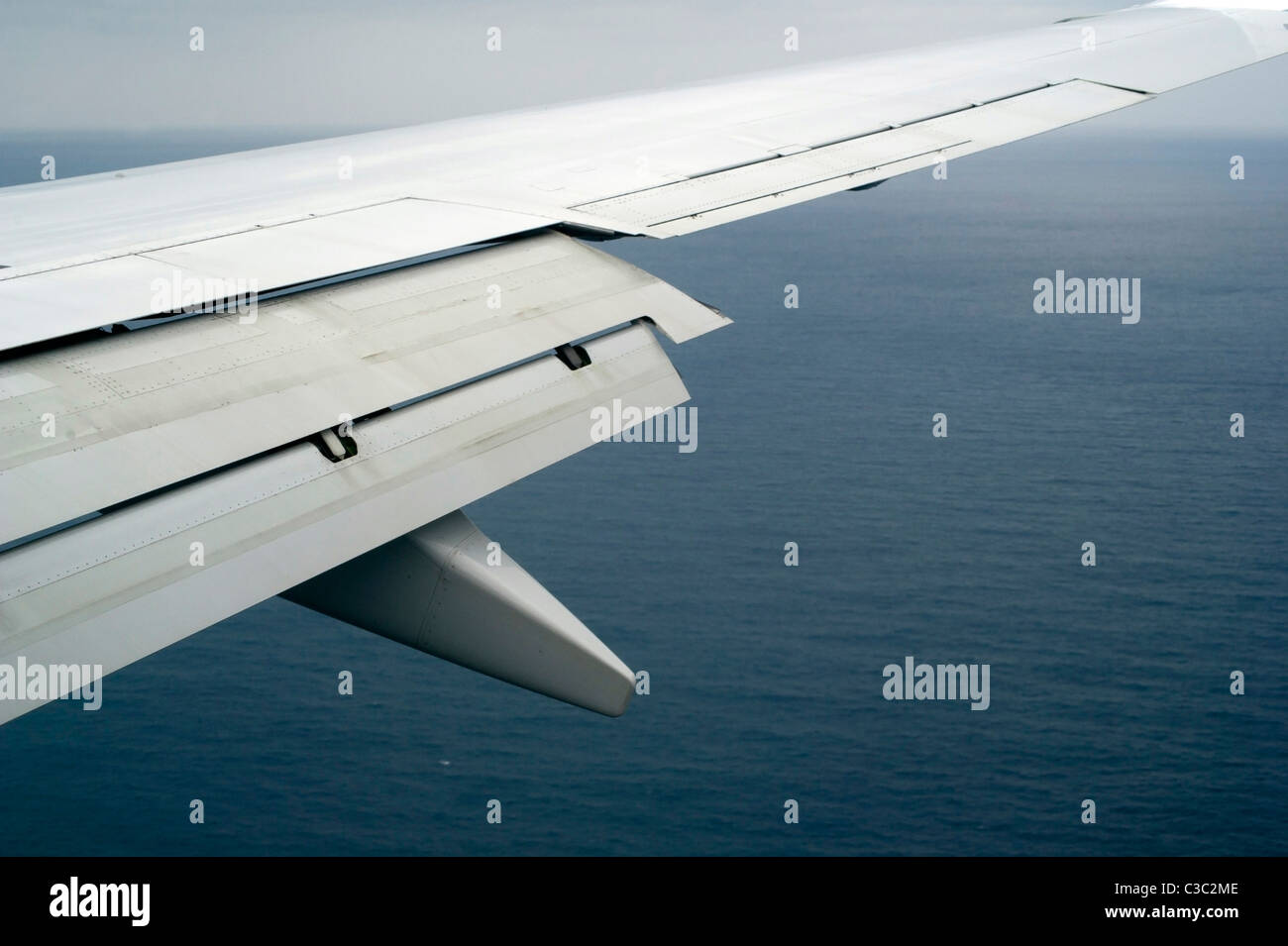 Airplane flying over the ocean preparing for landing on Bermuda Stock ...