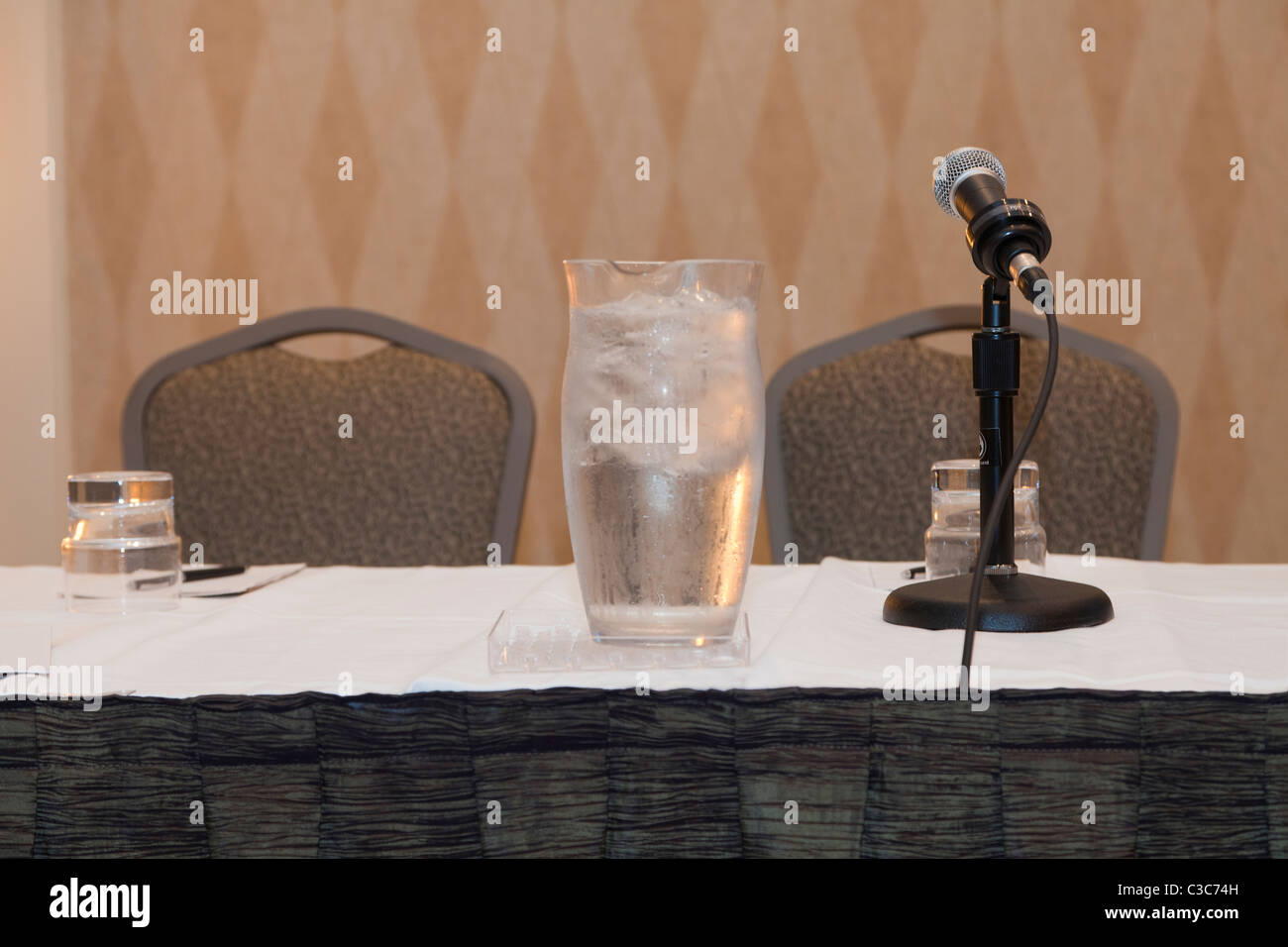Table with microphone and chairs in conference room Stock Photo - Alamy