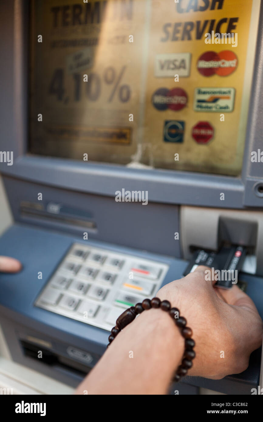 man using ATM machine in Europe Stock Photo - Alamy