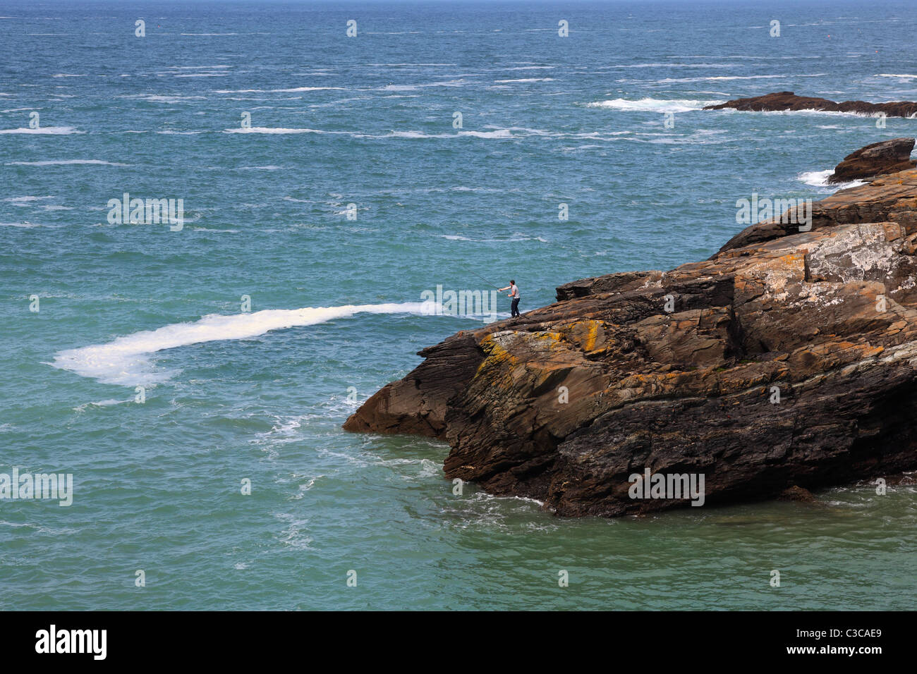 A man fishing on Barras Nose cliff face at Cornwall England UK English ...