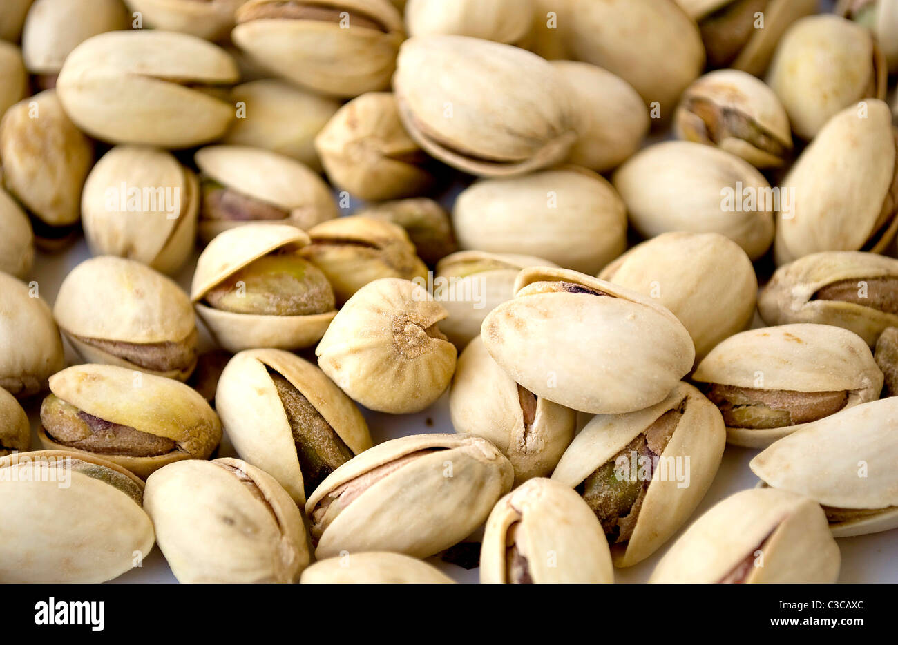 pile of pistachio nuts isolated on white background Stock Photo - Alamy