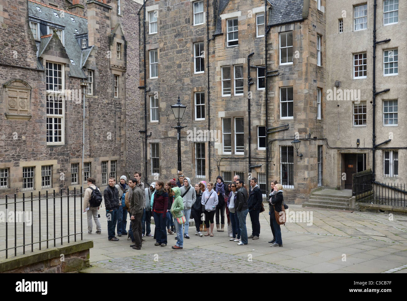 A group of tourists on a guided tour visit Lady Stairs Close in the ...