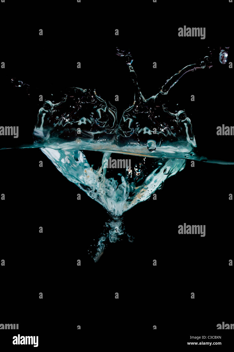 blue water shaped as a heart on black background Stock Photo - Alamy
