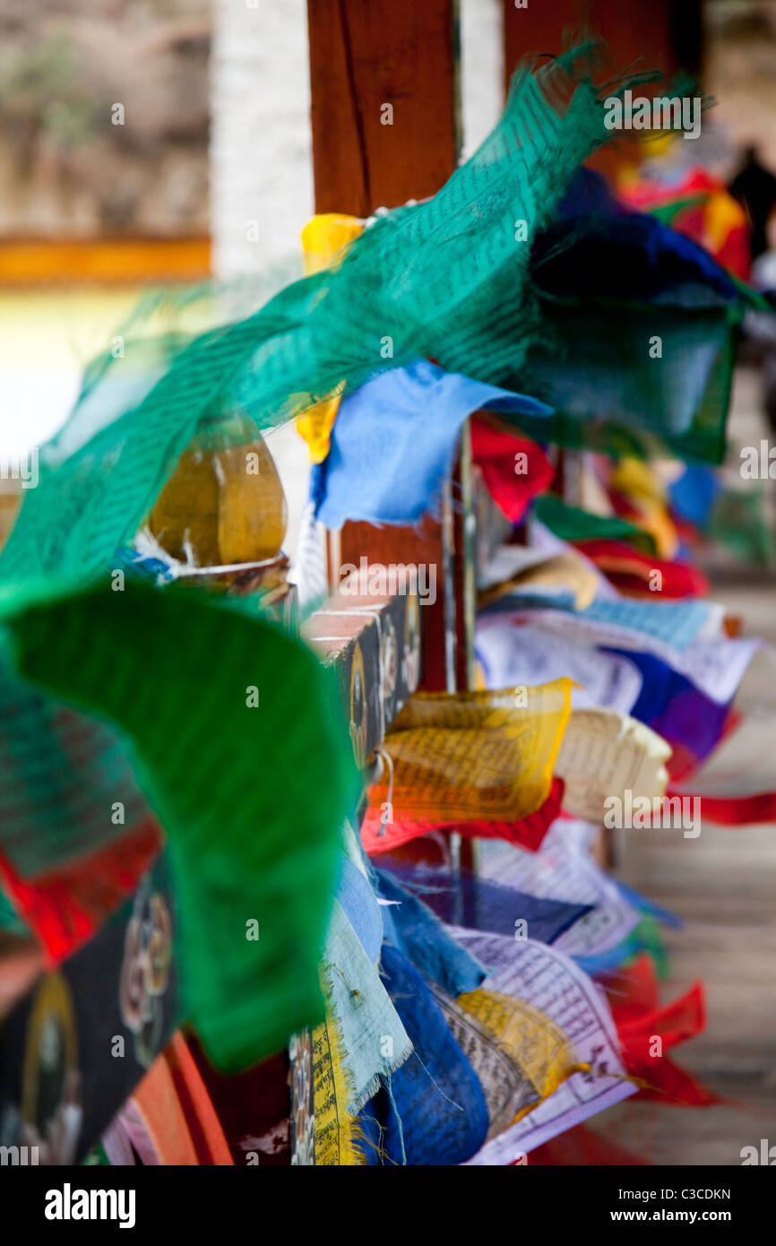 Prayer flags blowing in the wind on a bridge in Bhutan Stock Photo - Alamy