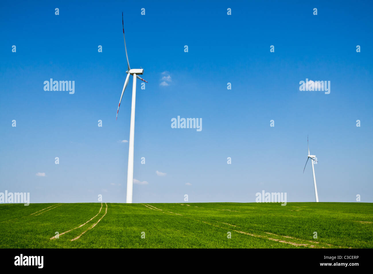 Alternative energy wind turbines on green field Stock Photo - Alamy