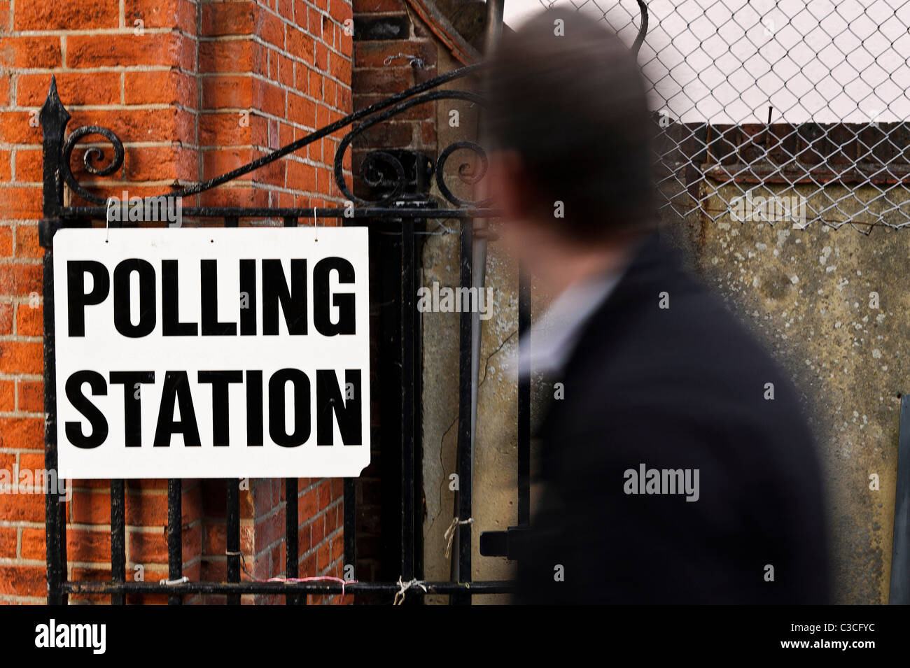 Voters enter and exit the Worthing Central polling station whilst ...