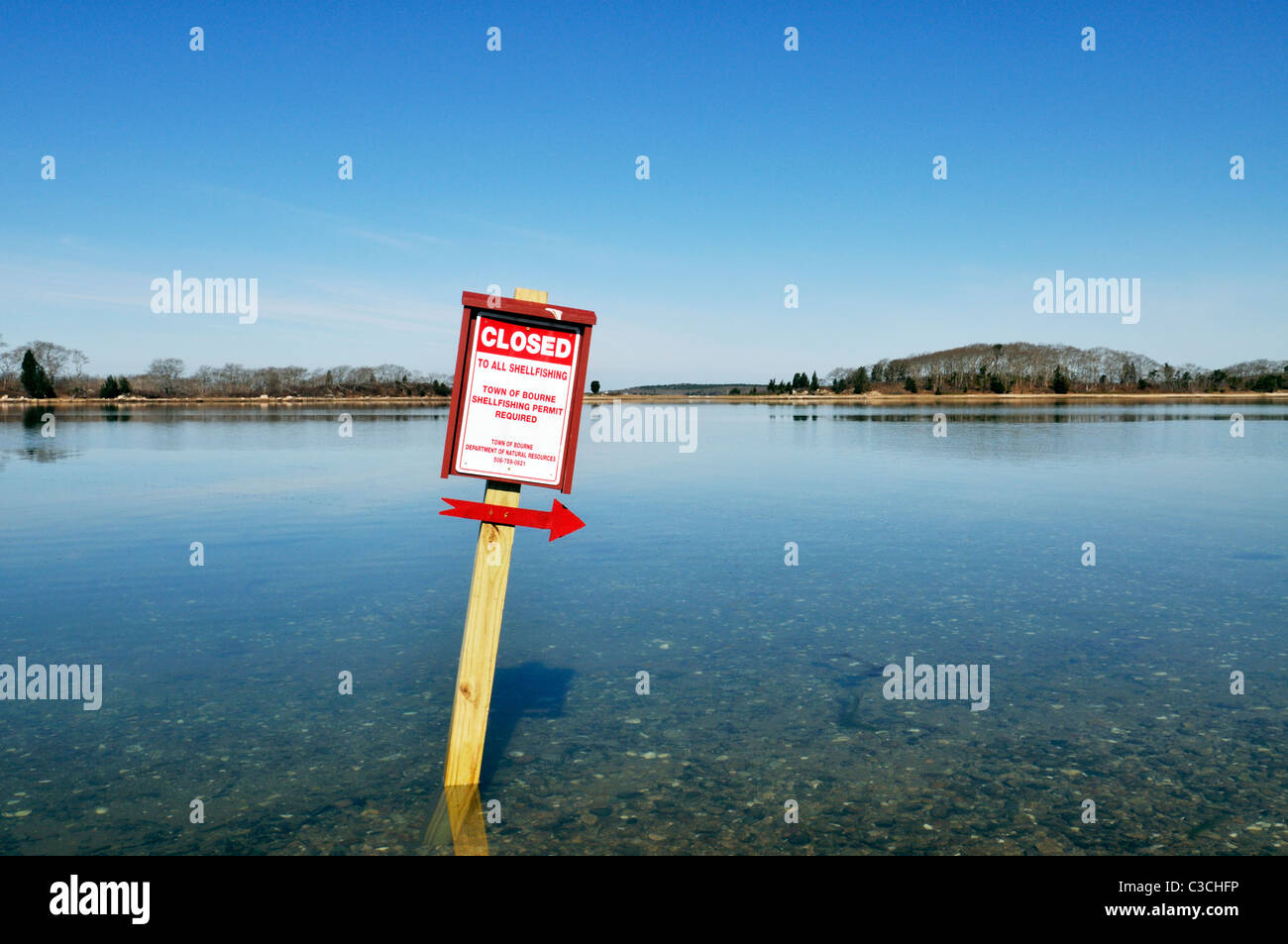 Closed to all shellfishing sign with red arrow posted at a edge of ...
