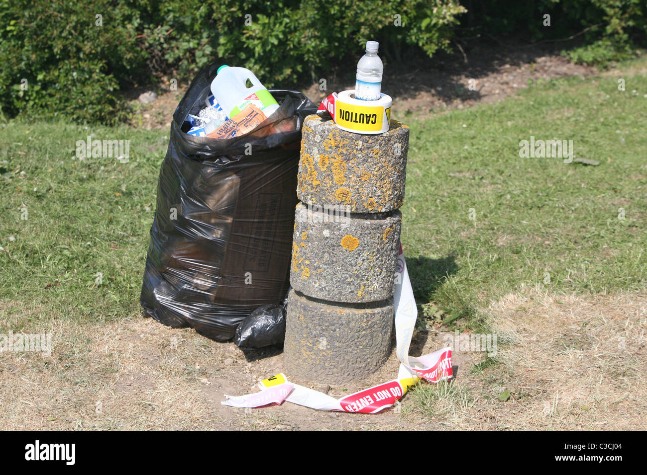 rubbish dumped on a grass verge Stock Photo - Alamy