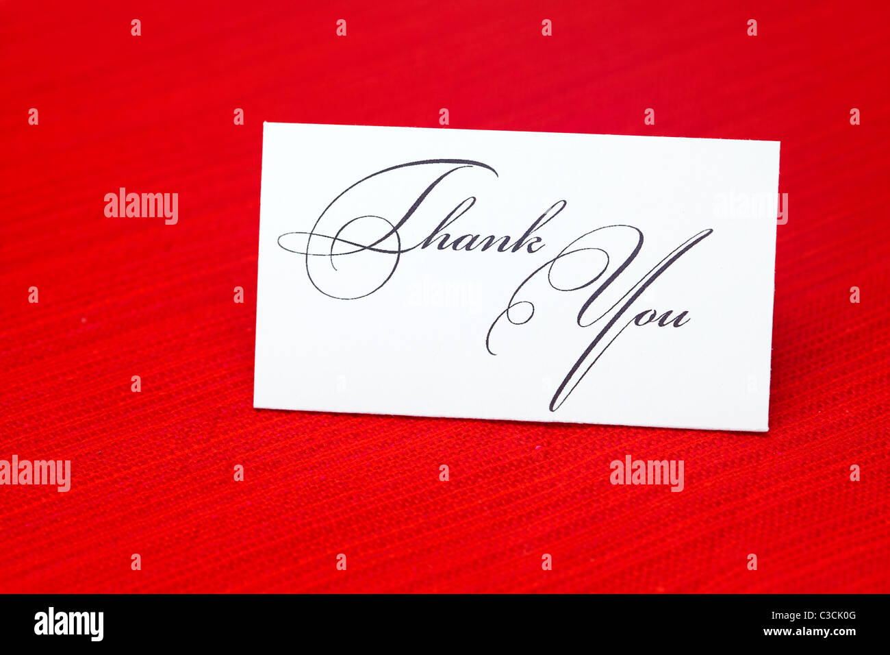 card signed thank you on a red background Stock Photo - Alamy