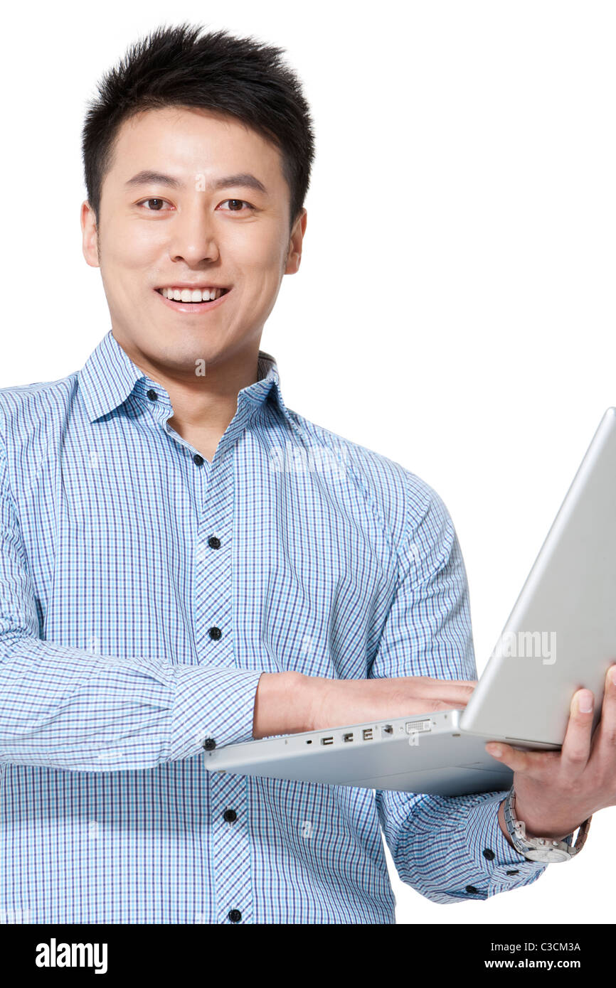 Man holding up and using a laptop Stock Photo - Alamy