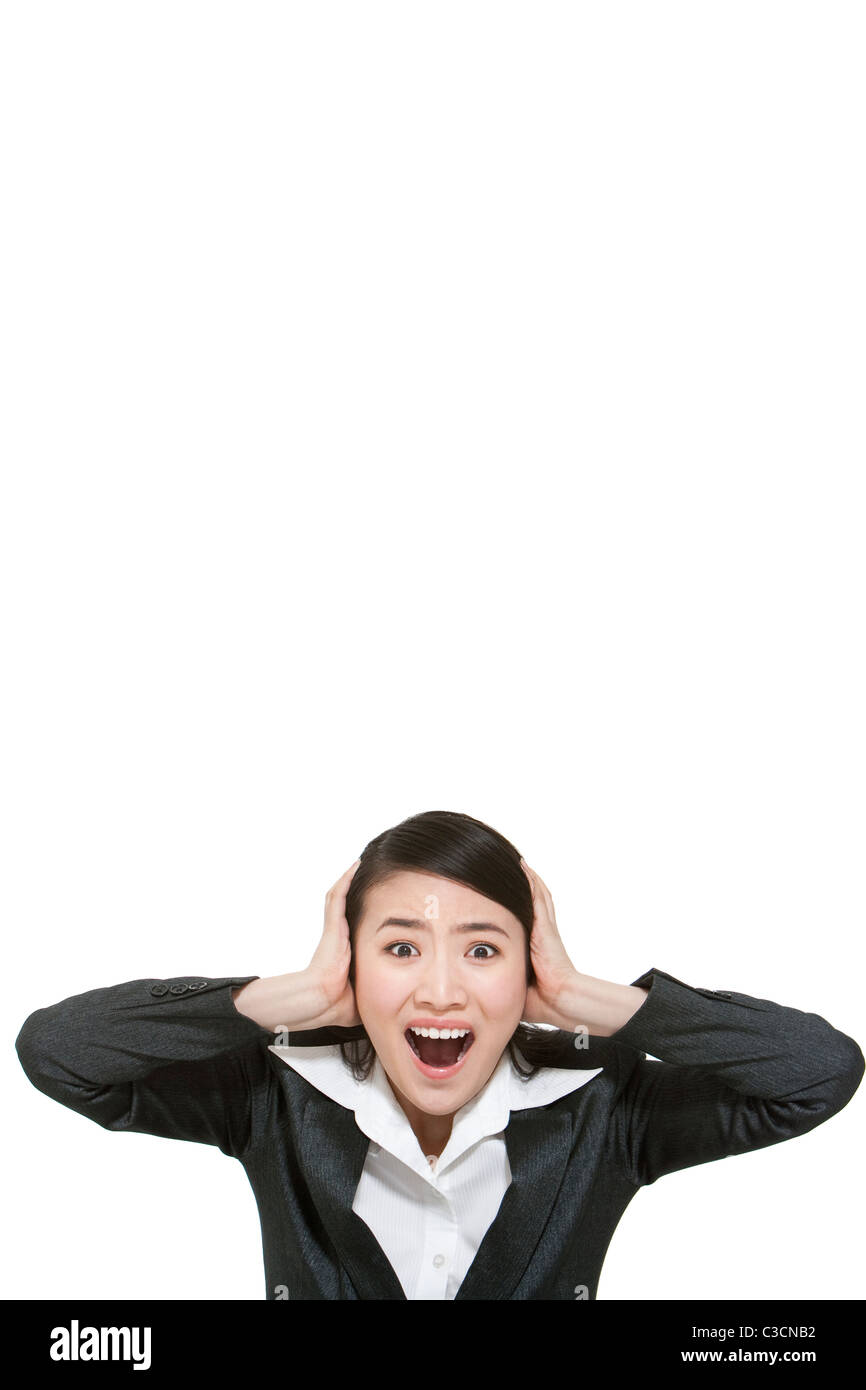 A businesswoman covering her ears Stock Photo - Alamy