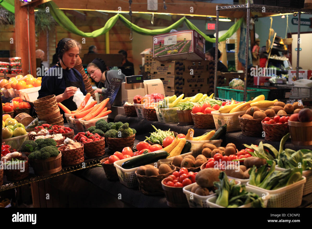 Amish woman selling local products at St. Jacobs farmers' market in ...