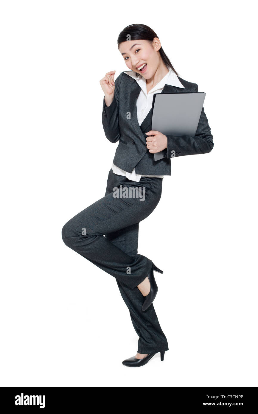 A dancing businesswoman holding a file folder Stock Photo - Alamy