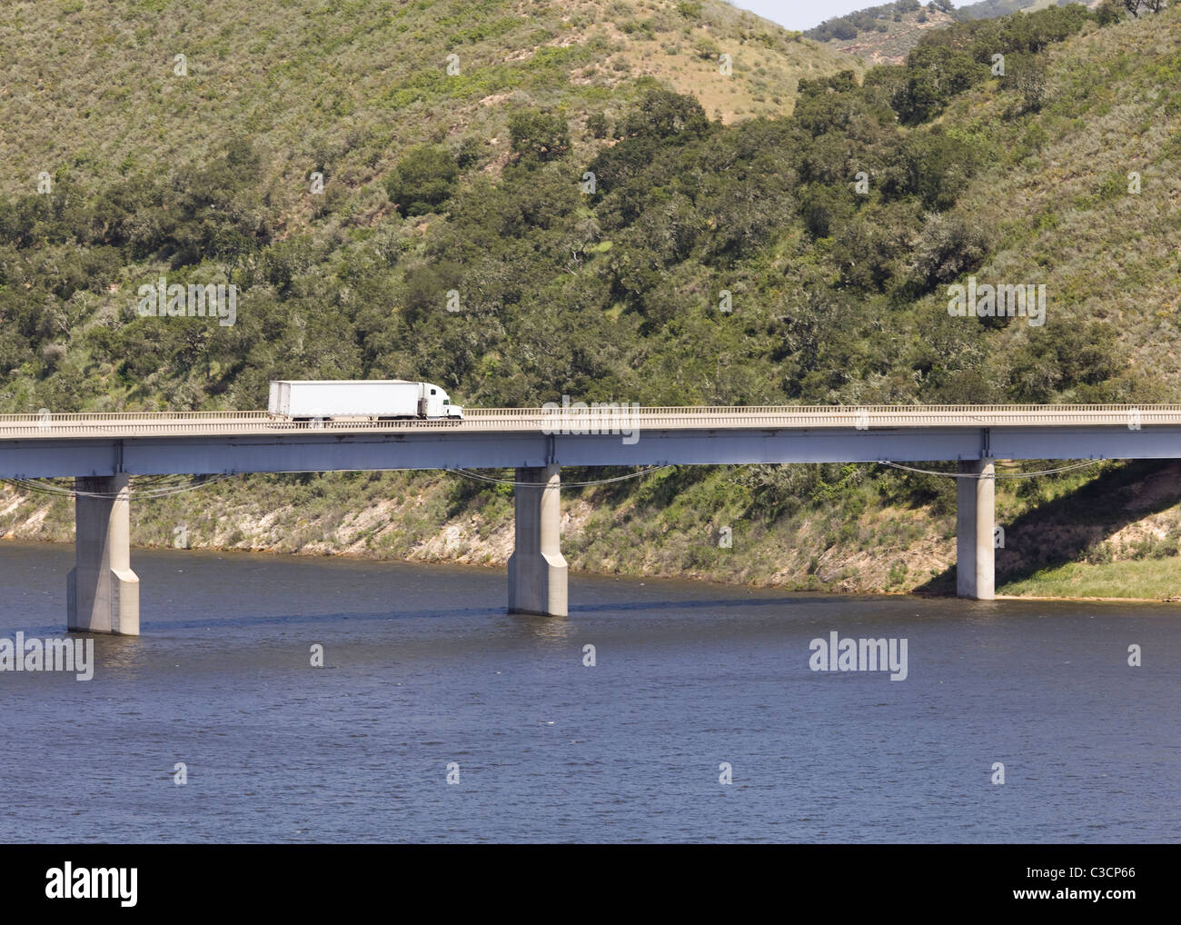Tractor-trailer truck crossing a river on bridge Stock Photo - Alamy