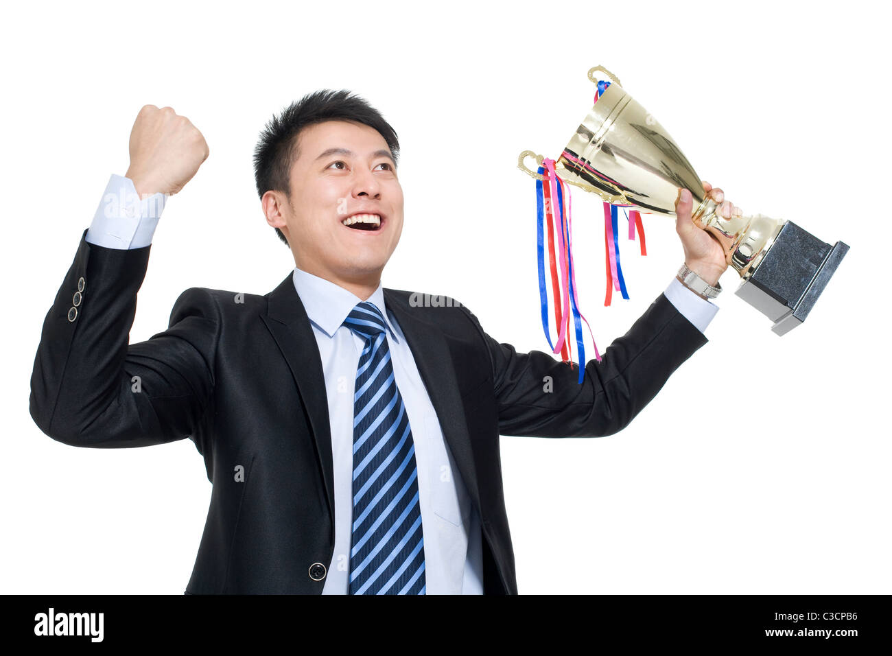 Triumphant businessman holding a trophy Stock Photo - Alamy