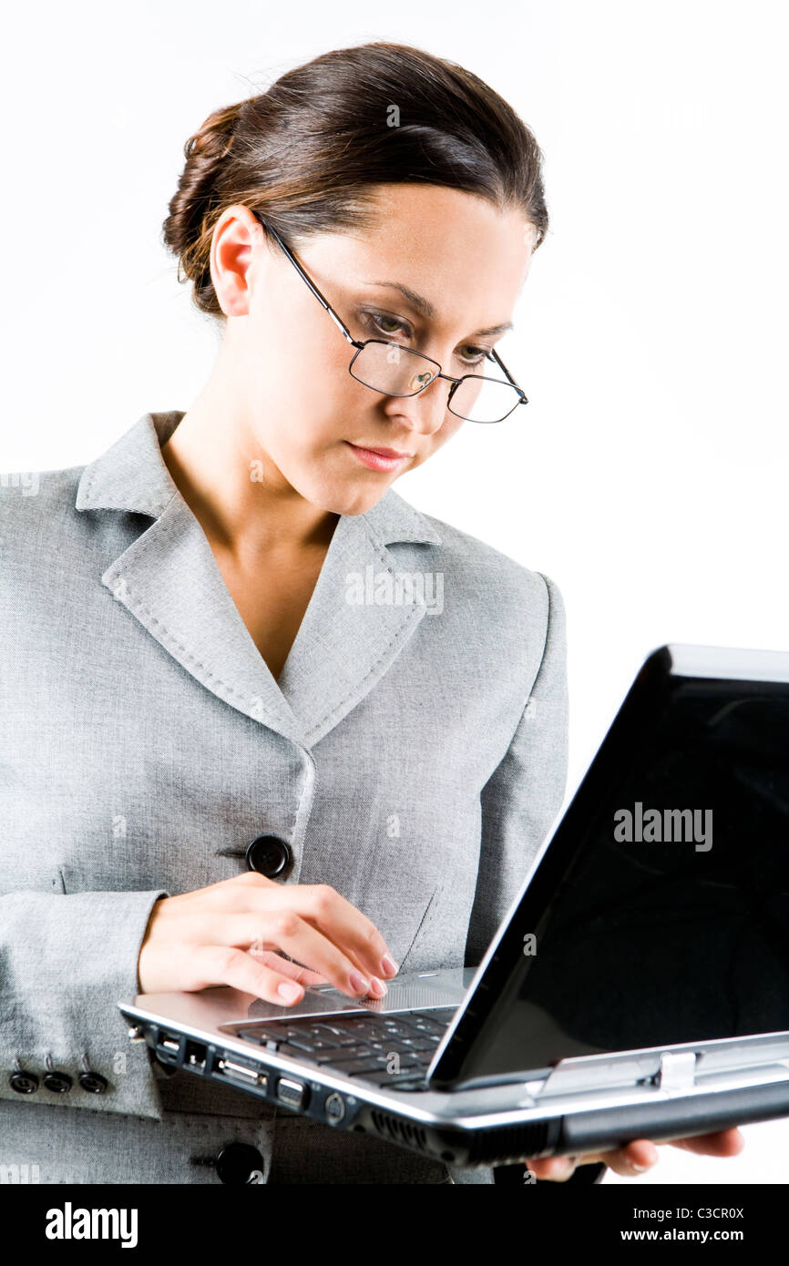 Portrait of businesswoman typing on laptop over white background Stock ...