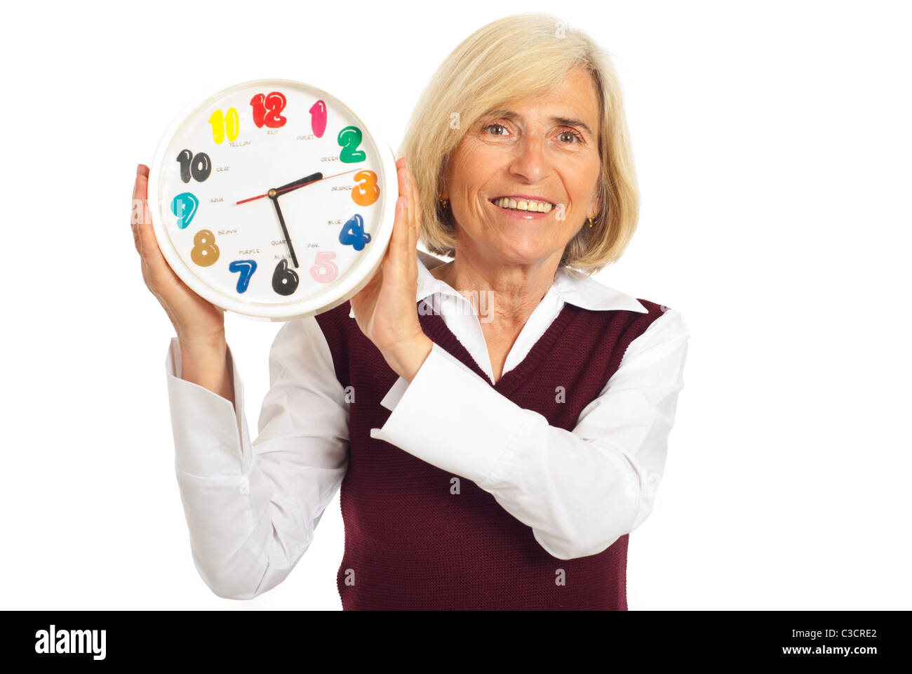 Laughing senior woman holding clock isolated on white background Stock ...