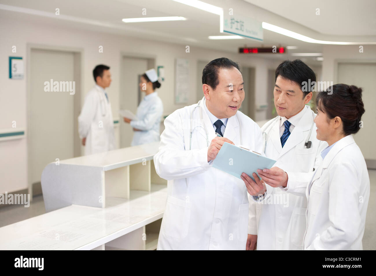 An older doctor smiles to his fellow doctor Stock Photo - Alamy