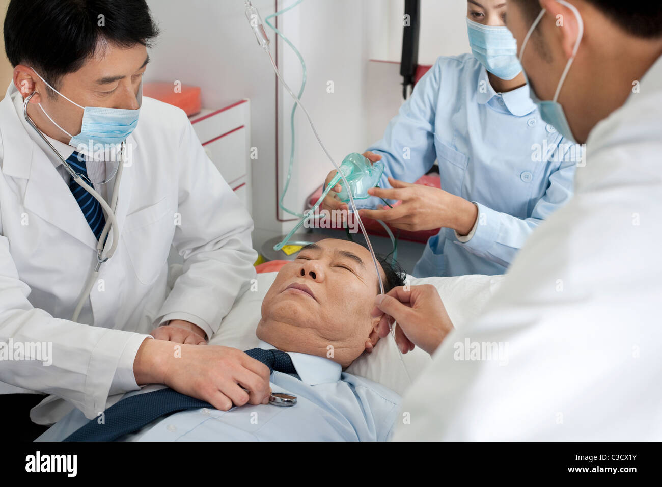 Medics treating a patient in an ambulance Stock Photo - Alamy