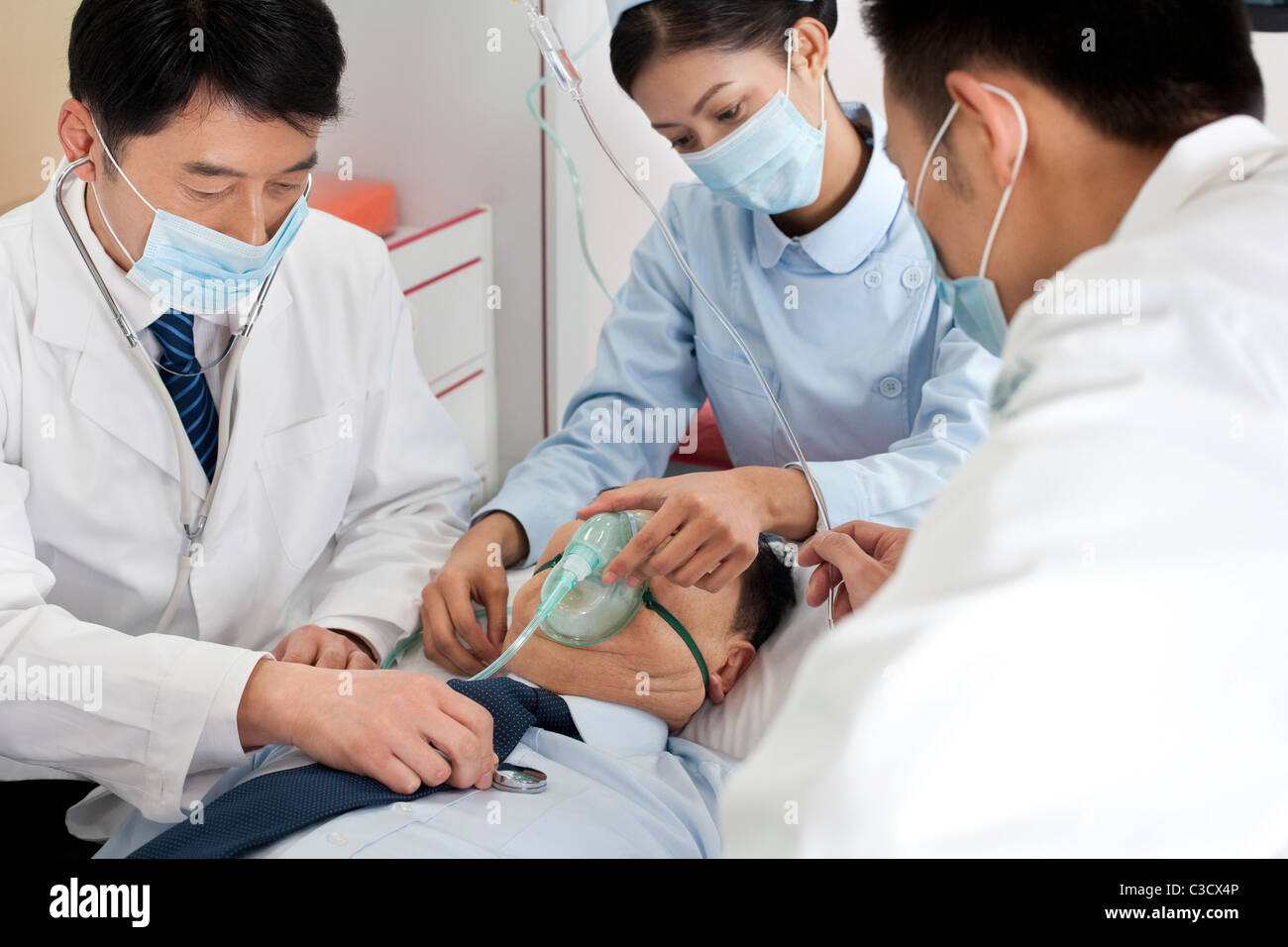 Medics treating a patient in an ambulance Stock Photo - Alamy