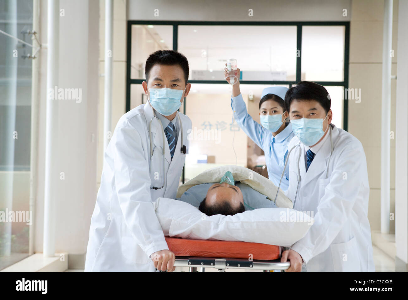 Medic team transporting a patient on a stretcher Stock Photo - Alamy