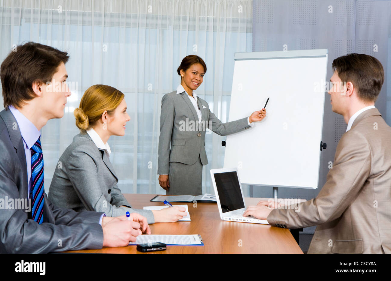 Photo of confident employer teaching business people how to manage ...