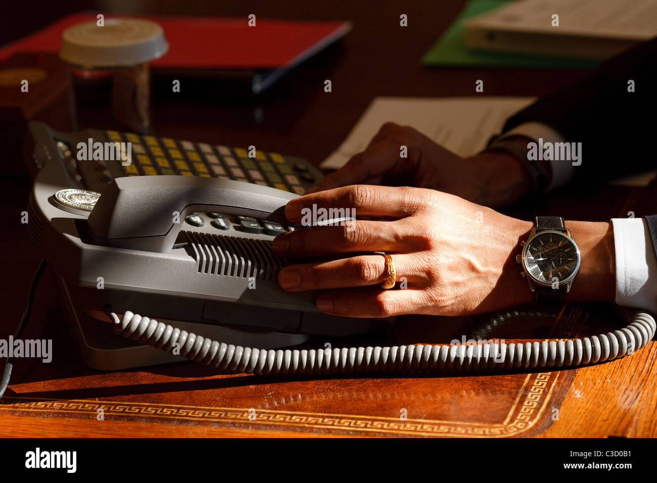 US President Barack Obama places a phone call at his desk in the Oval ...